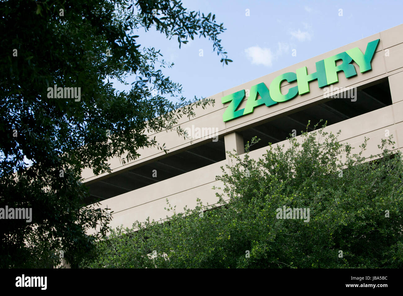 A logo sign outside of a facility occupied by the Zachry Group in ...
