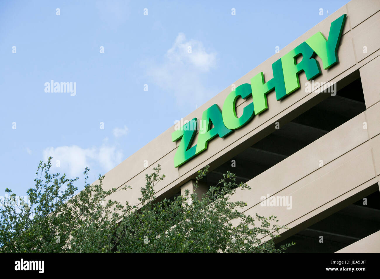 A logo sign outside of a facility occupied by the Zachry Group in ...