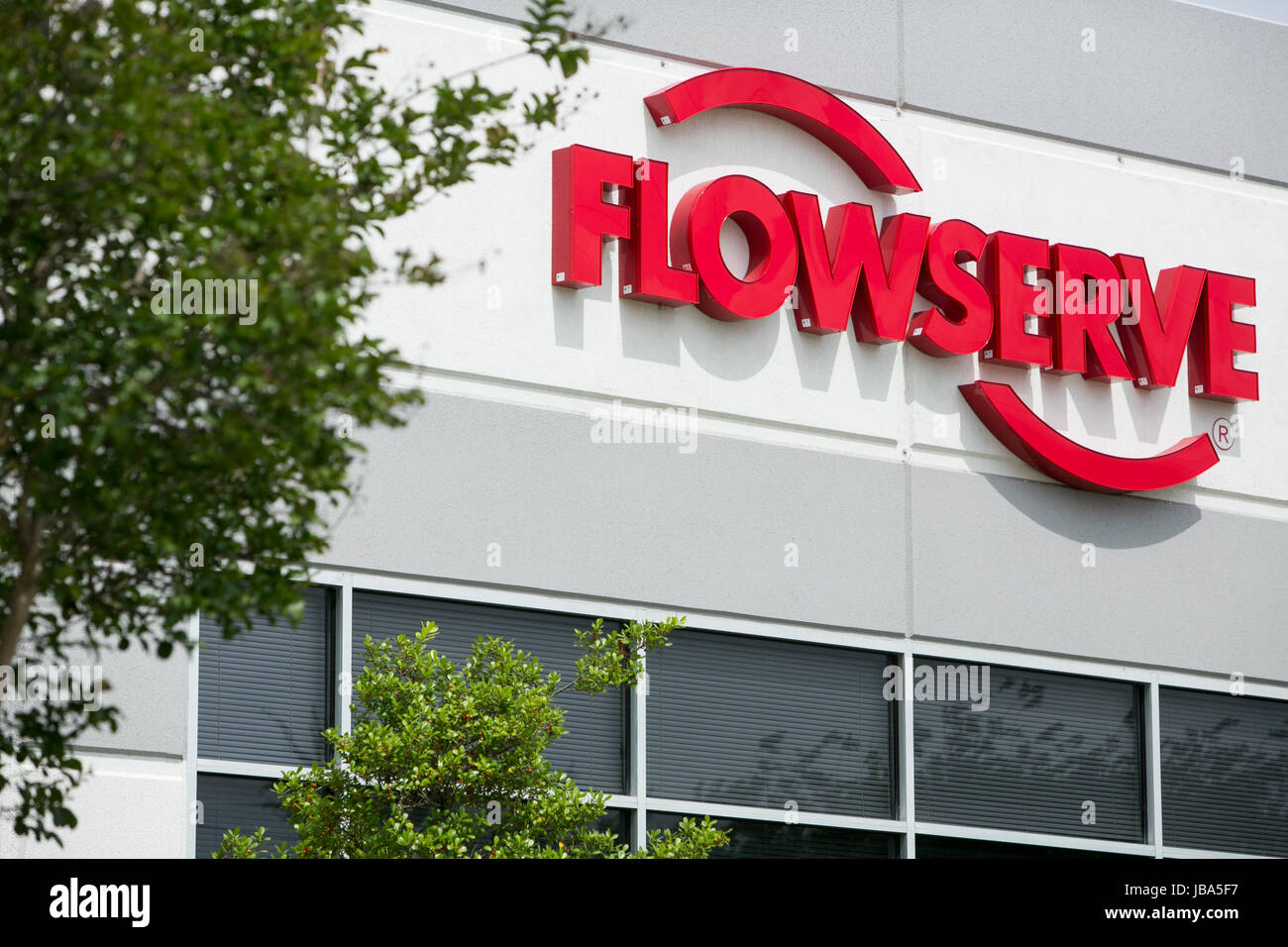 A logo sign outside of a facility occupied by the Flowserve Corporation ...