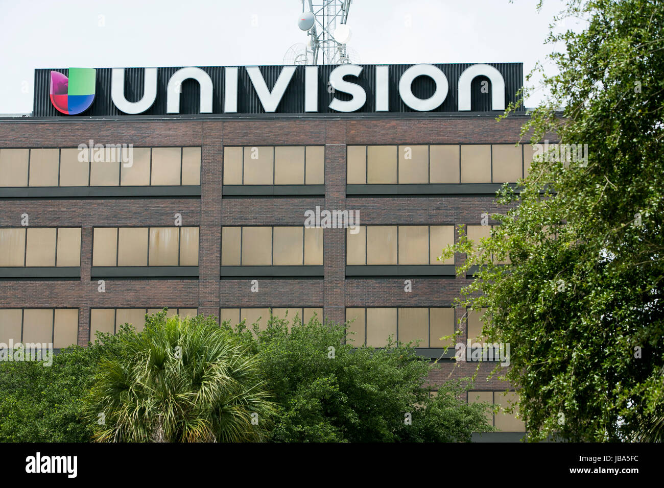 A logo sign outside of a facility occupied by Univision Communications ...