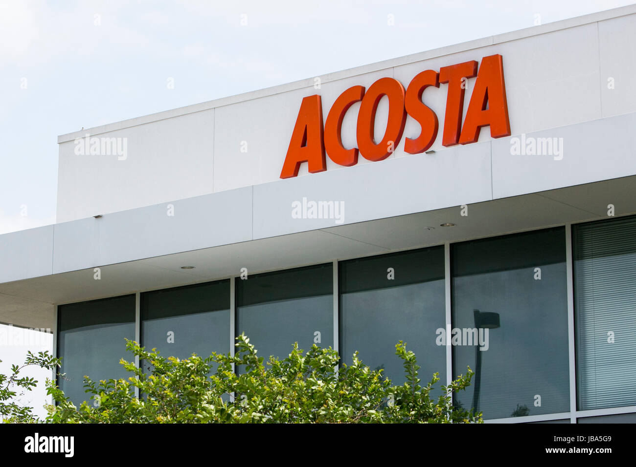 A logo sign outside of a facility occupied by Acosta Sales & Marketing ...