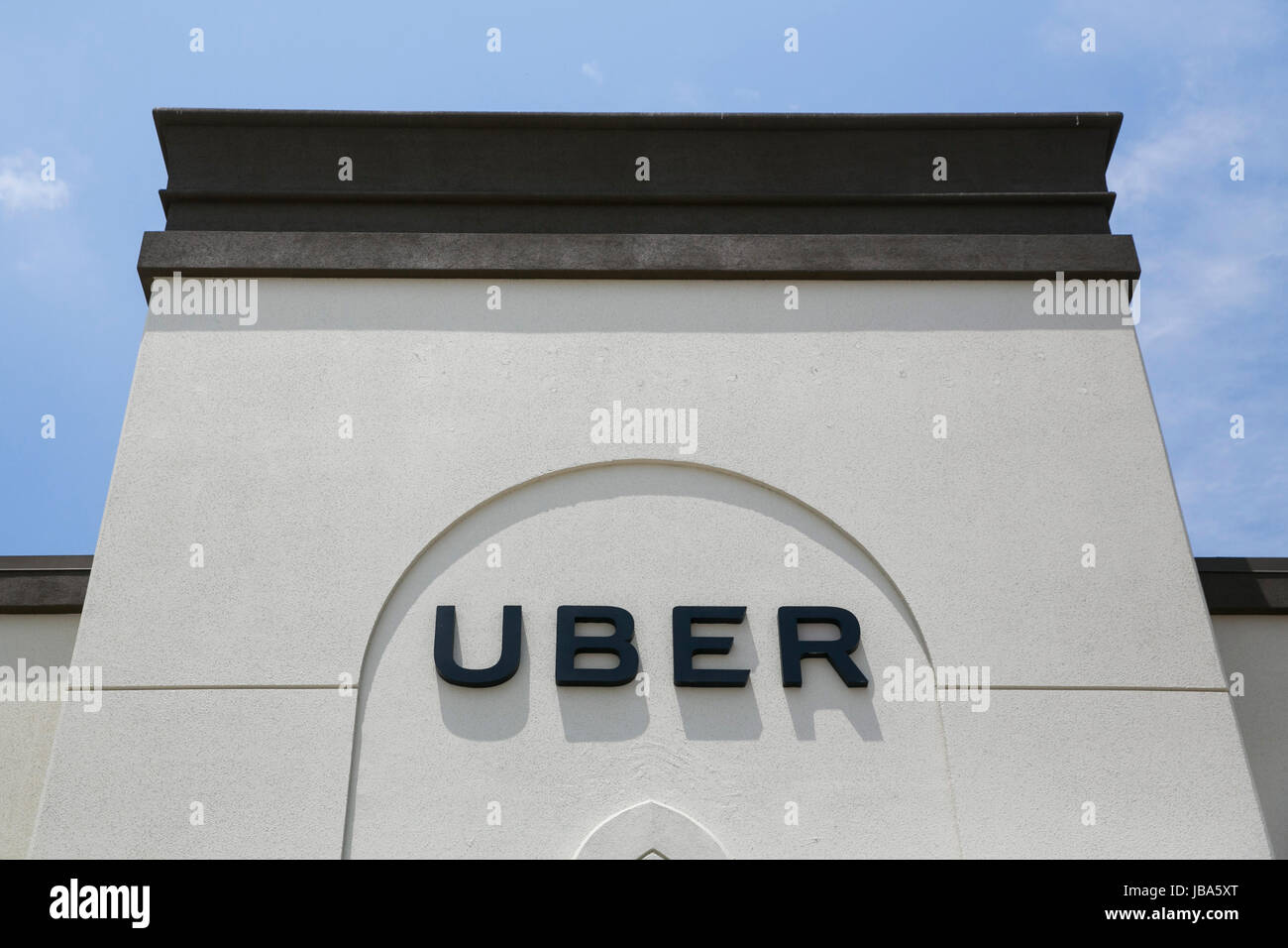 A logo sign outside of a Uber Technologies regional office in Houston ...