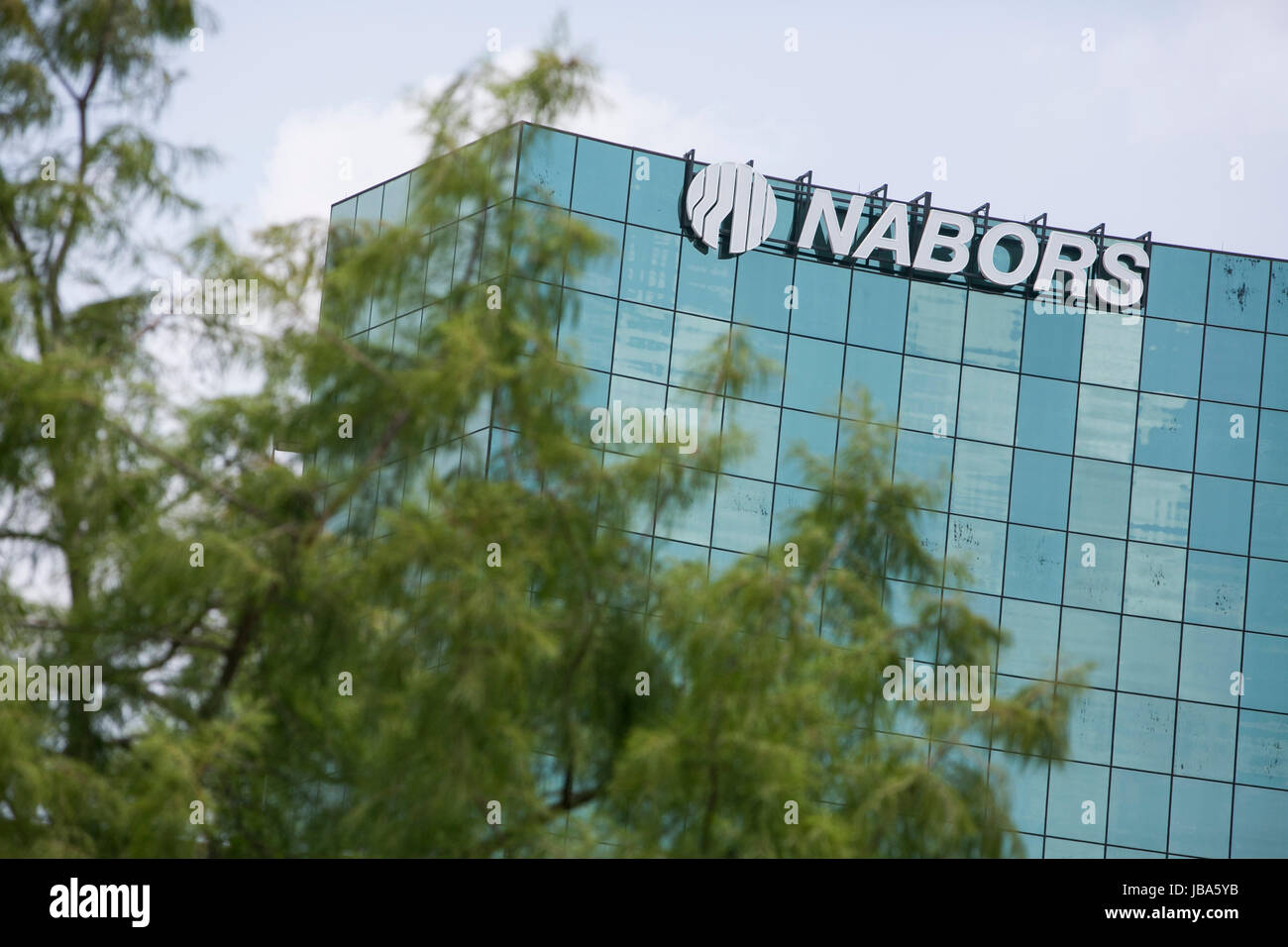 A logo sign outside of a facility occupied by Nabors Industries Ltd, in ...