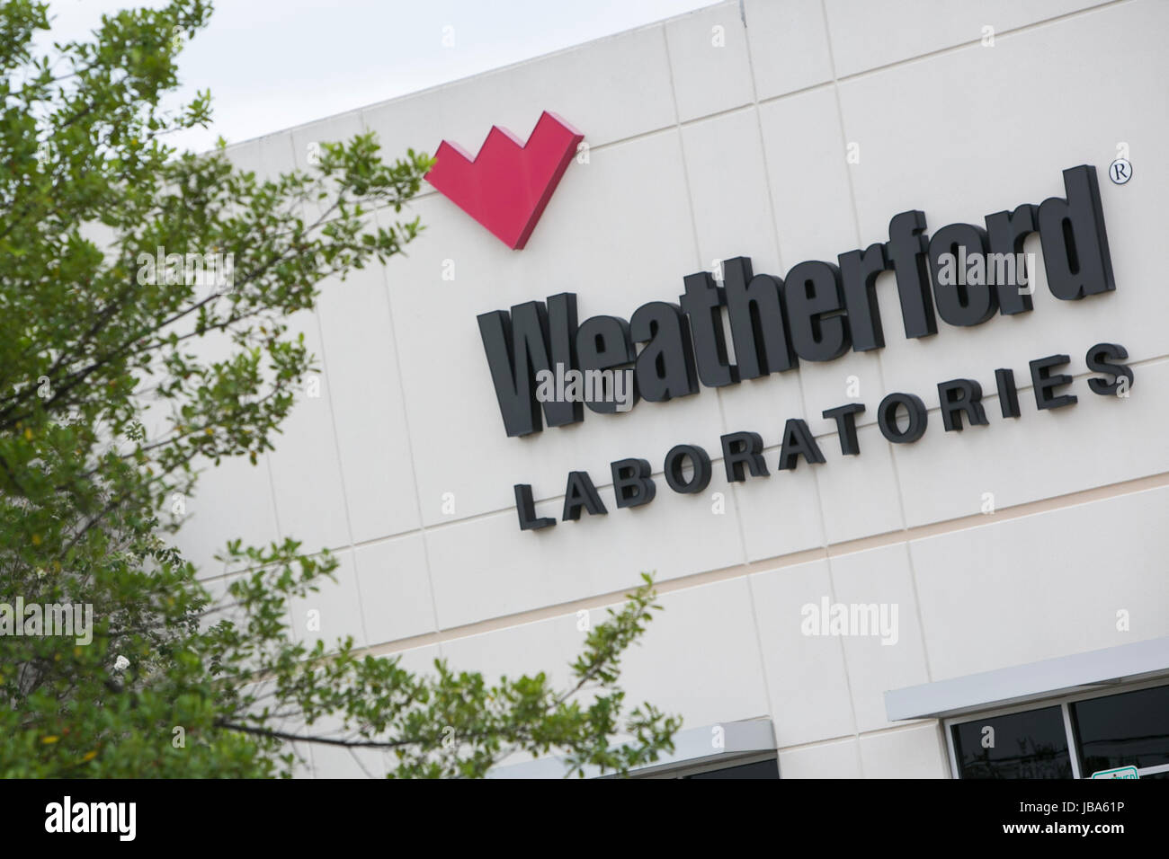 A logo sign outside of a facility occupied by Weatherford Laboratories ...