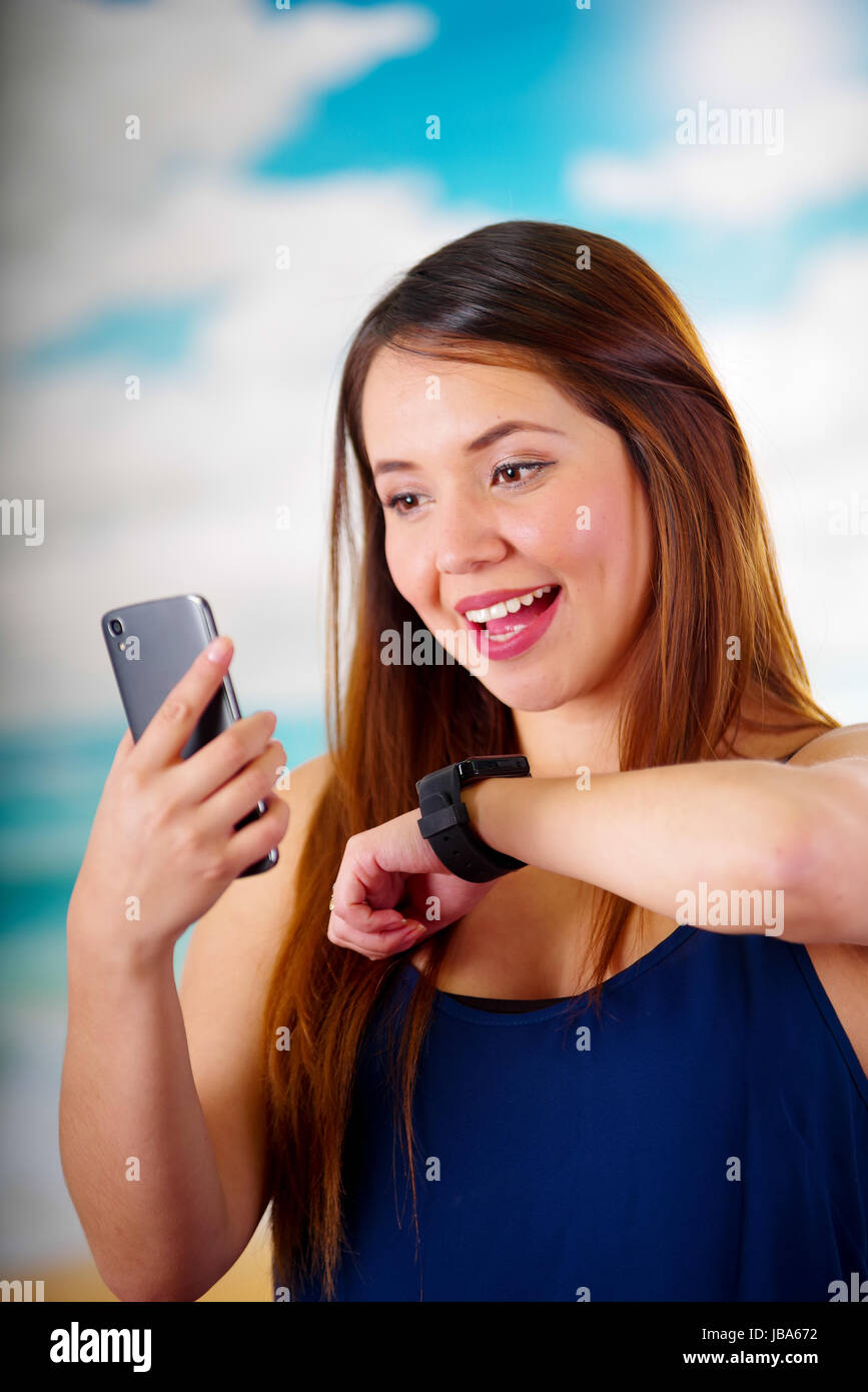 Business woman wearing in her wrist a smart watch with voice control ...