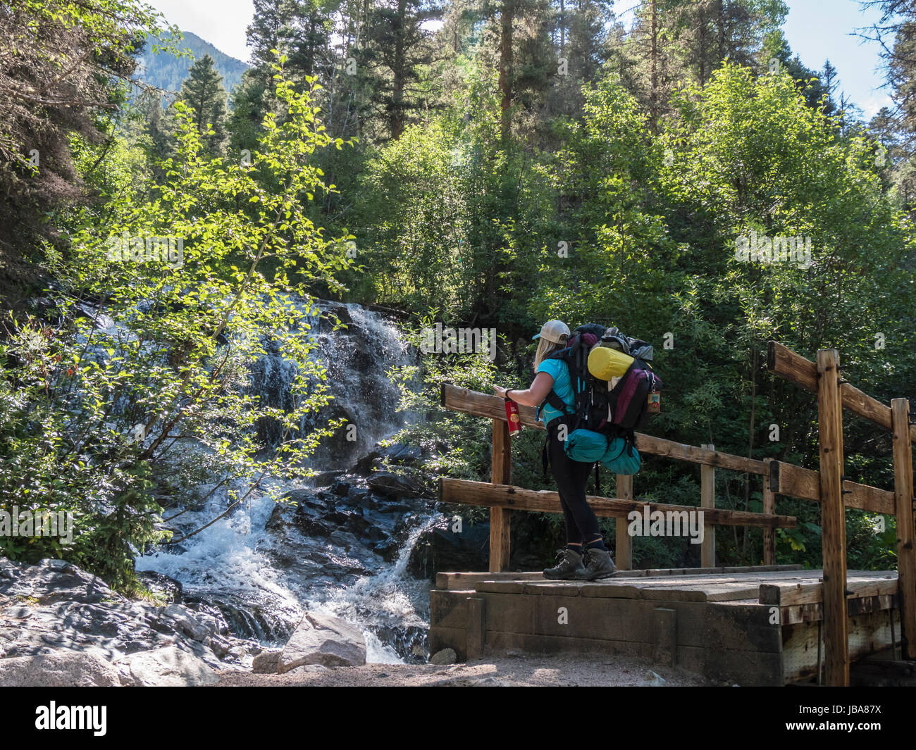 Backpacker admires New York Creek waterfall, Needle Creek Trail ...