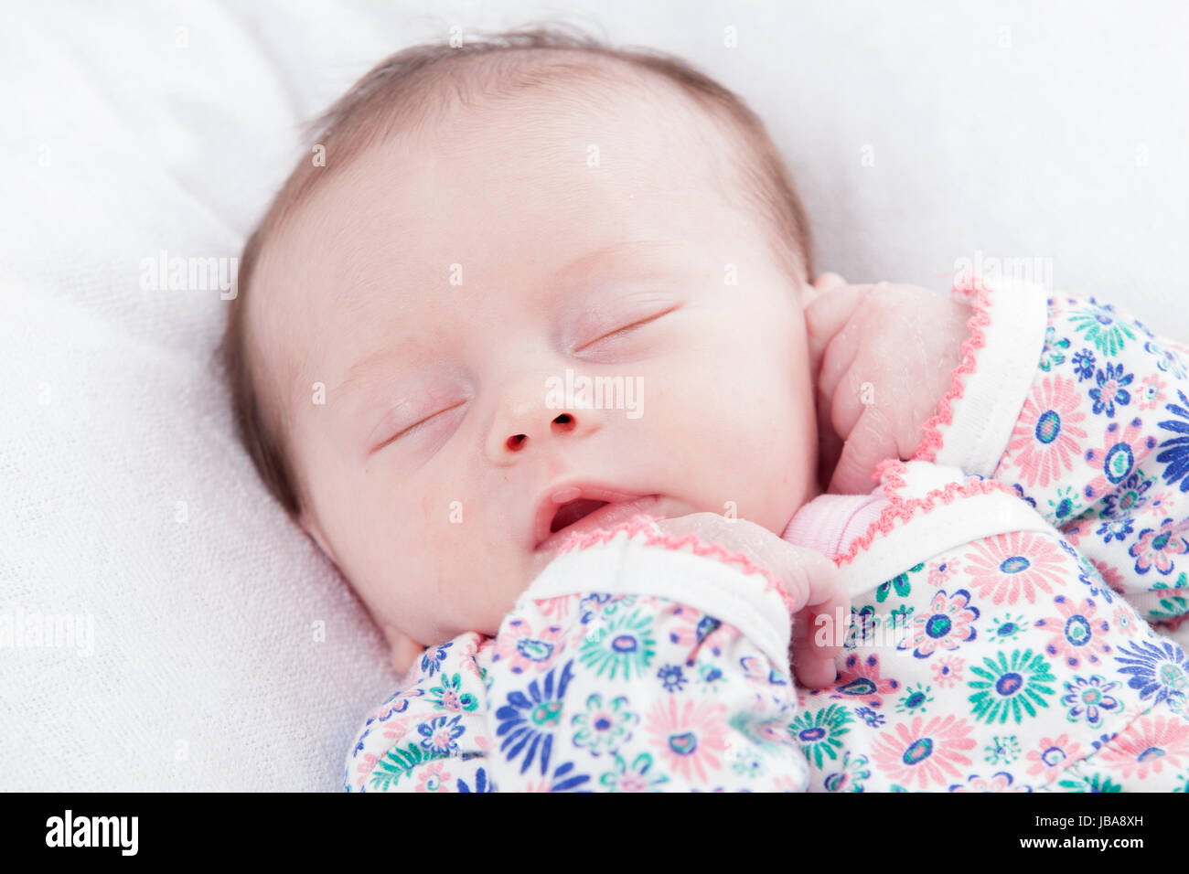 happy newborn baby girl just a week old photographed in the studio ...