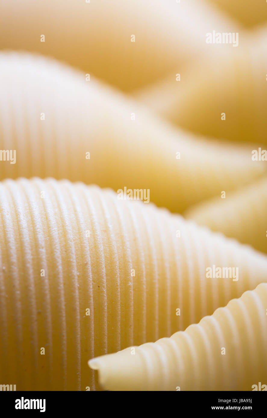 ribbed dry yellow macaroni with seriated line Stock Photo - Alamy