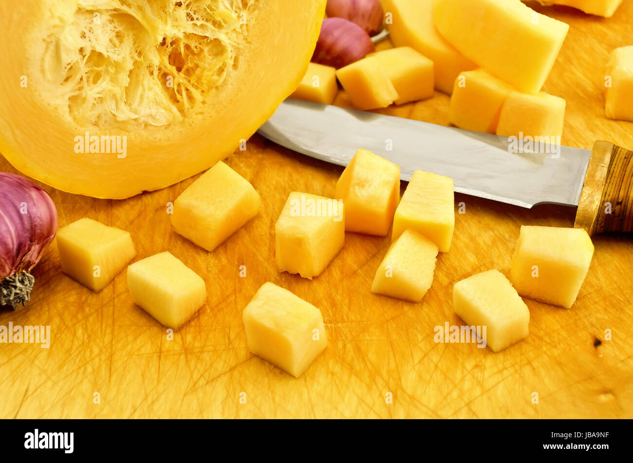 Cut the yellow squash, garlic and a knife on a wooden board Stock Photo ...
