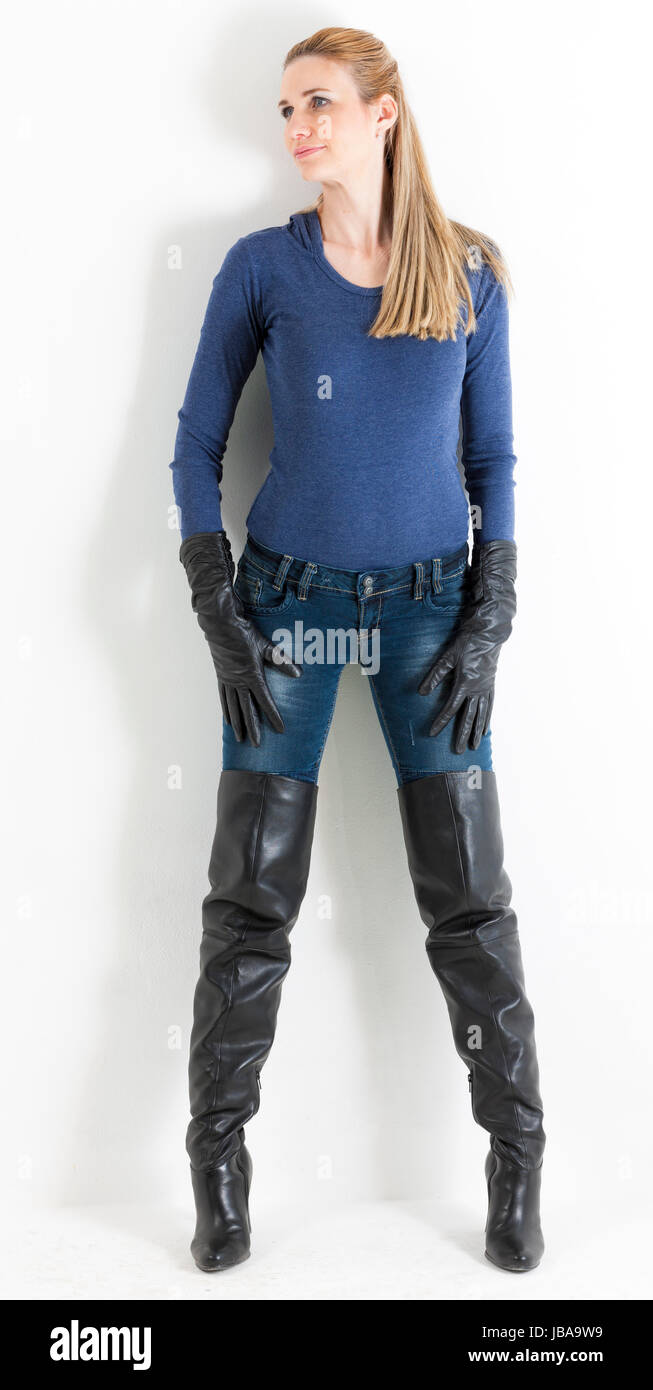 standing woman wearing jeans and black boots Stock Photo - Alamy