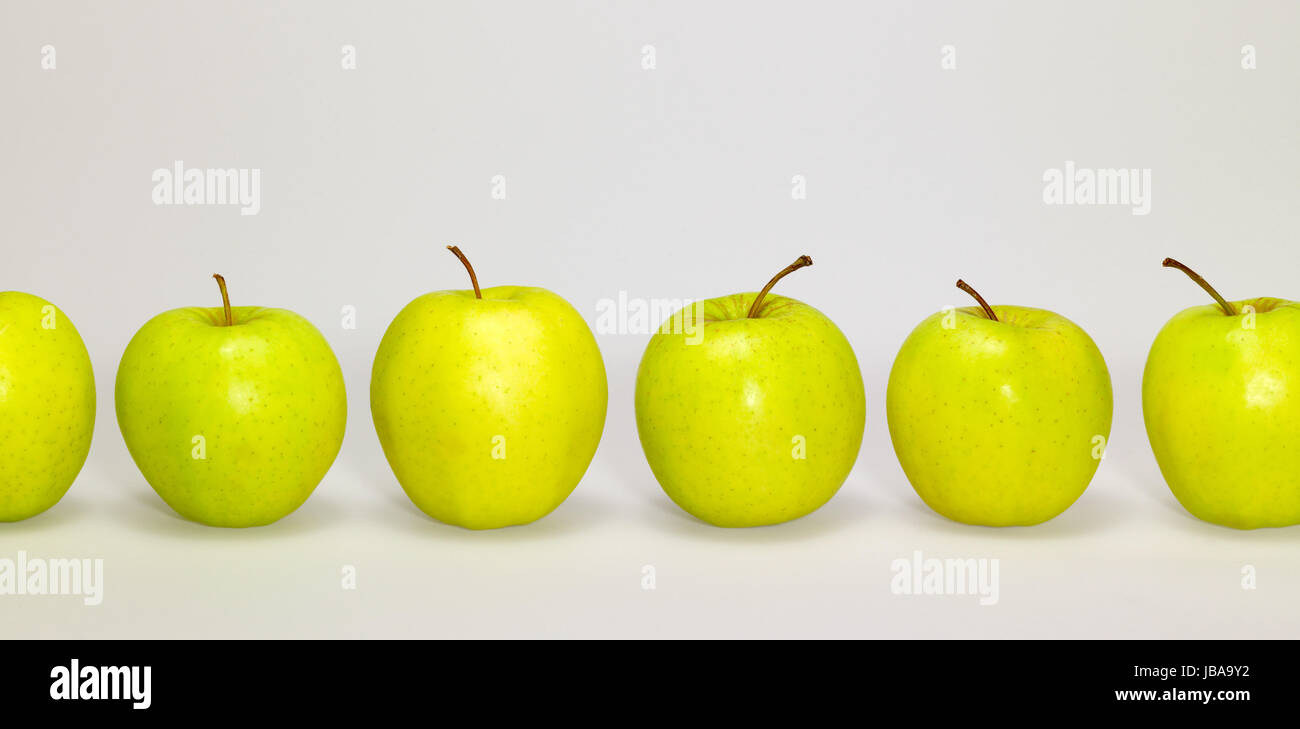 green apples in a row in light back Stock Photo - Alamy