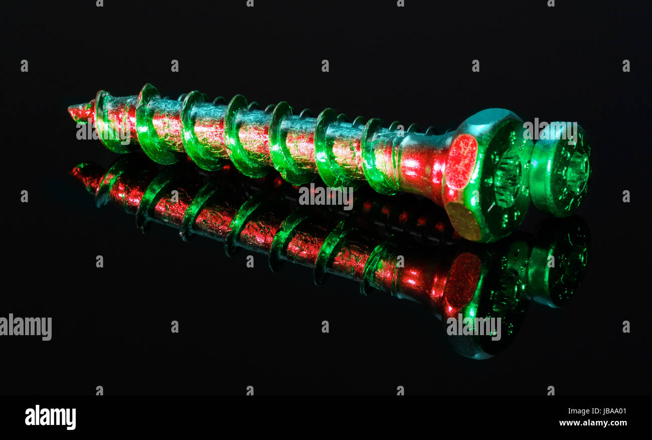 red and green illuminated screws in black reflective back Stock Photo ...