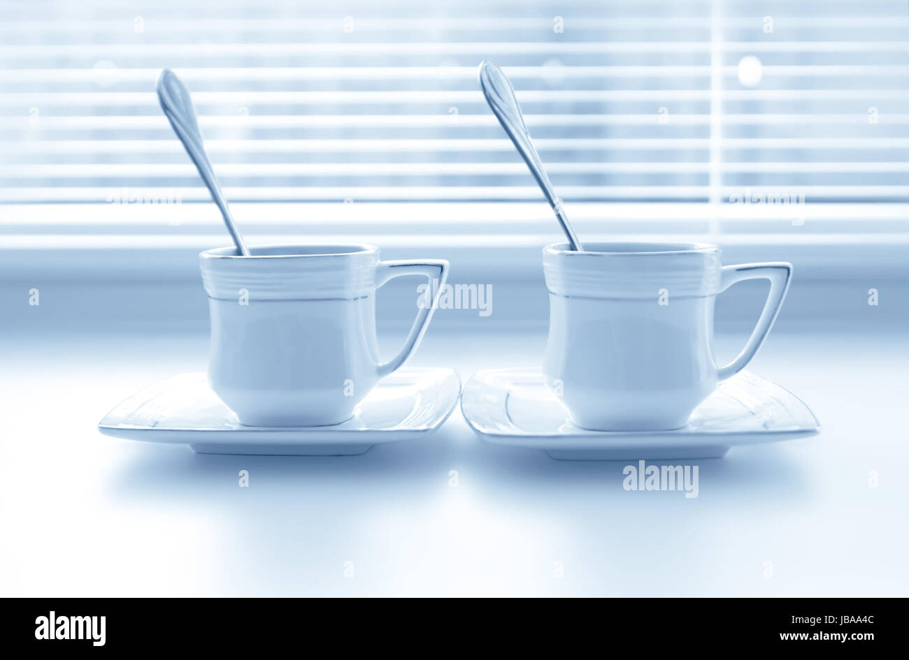 Two cups of coffee on the white windowsill with shutters Stock Photo ...