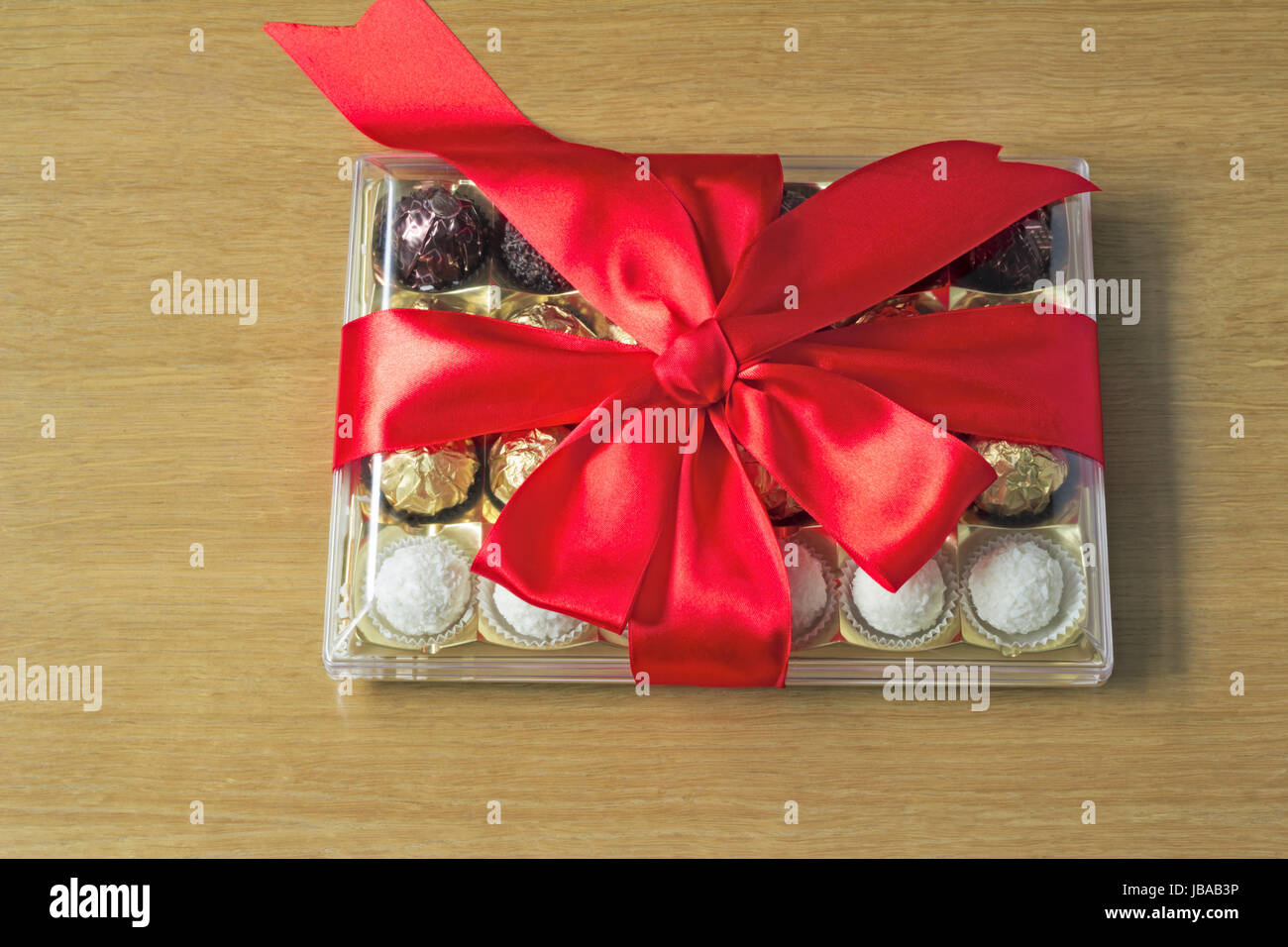 A beautifully decorated and tied with a ribbon box of chocolates, gift ...