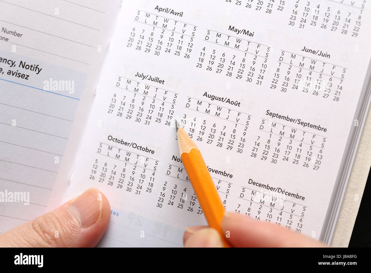 Checking important date on calendar Stock Photo - Alamy