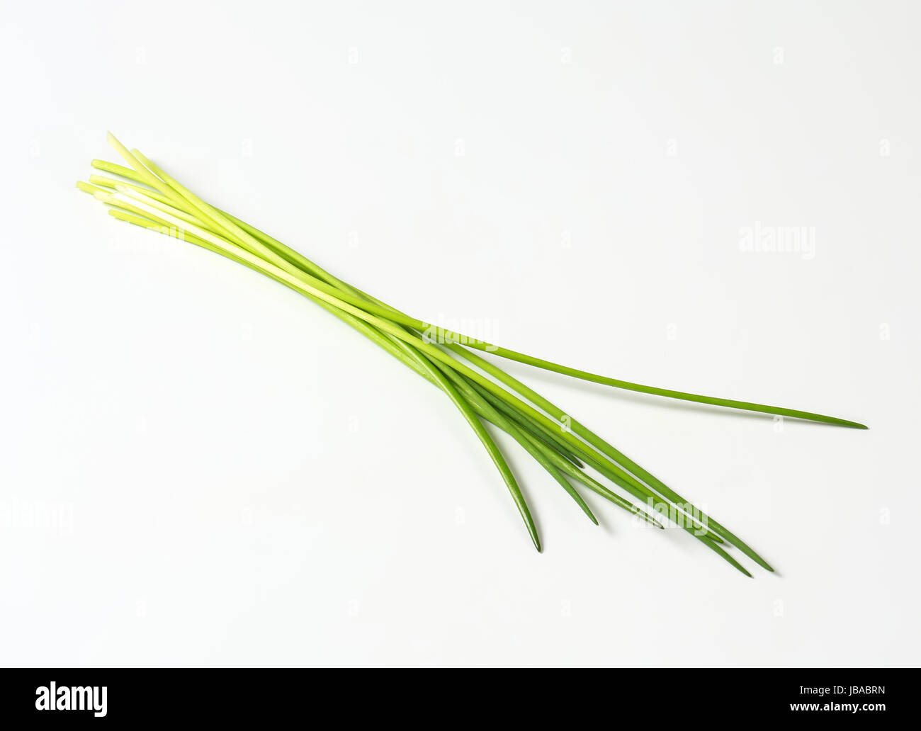 Fresh chives leaves on white background Stock Photo - Alamy