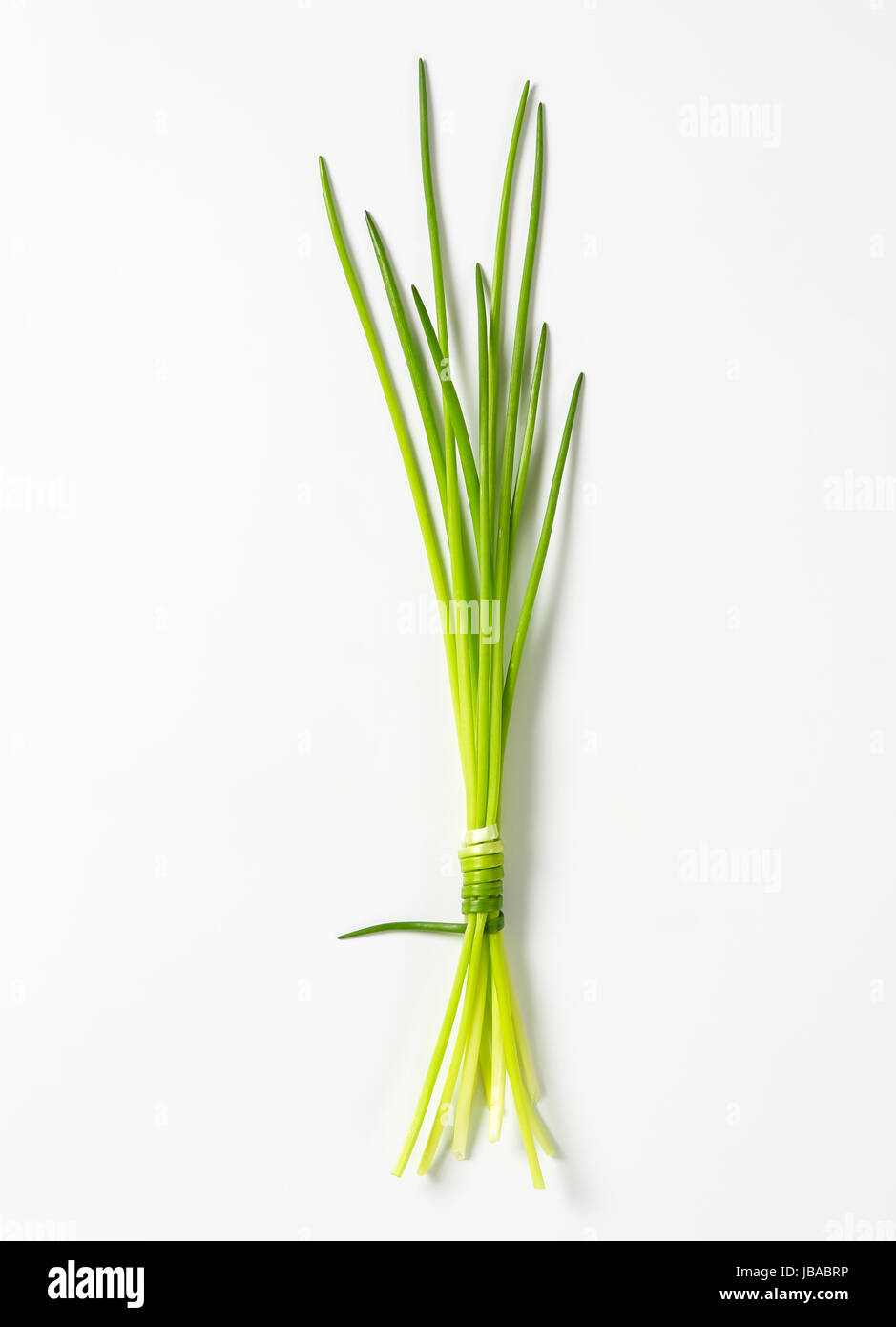 Bunch of fresh chives on white background Stock Photo - Alamy