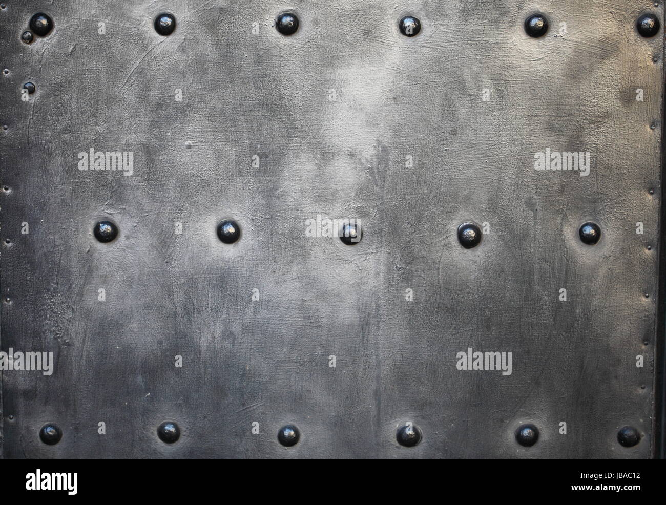 Black grunge metal plate or armour texture with rivets as background ...