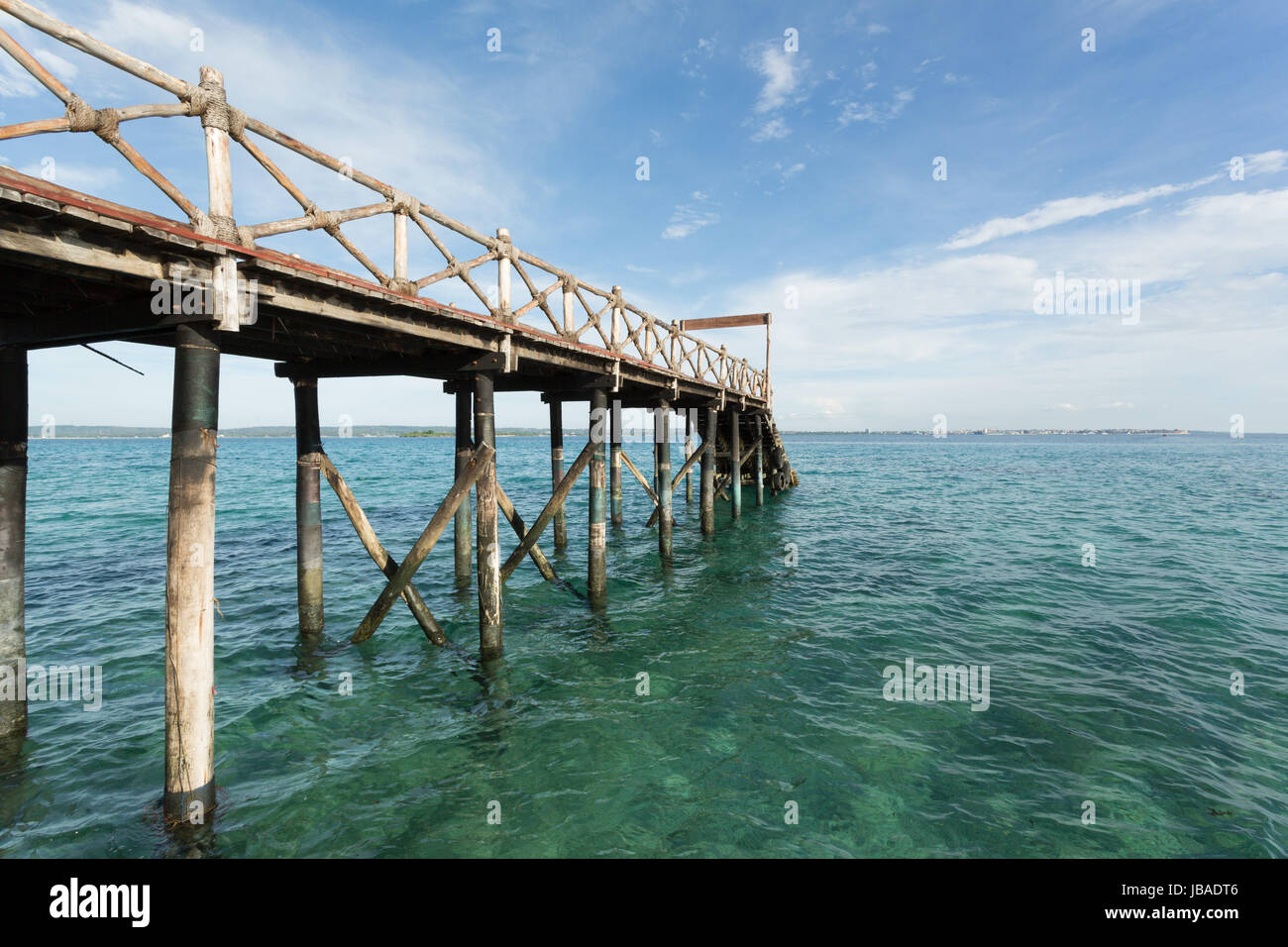 An old wooden bridge built on the shore of Prison Island in Zanzibar ...