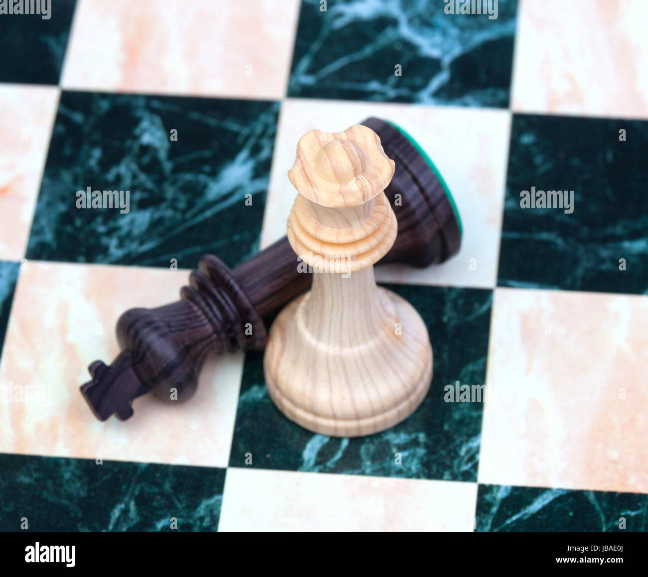 Checkmate. Wooden chess pieces on chessboard Stock Photo - Alamy