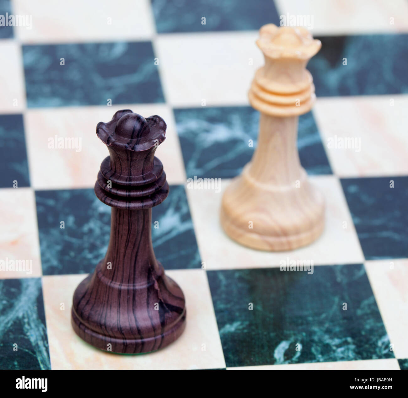 Two faced queens Wooden chess pieces on chessboard Stock Photo - Alamy