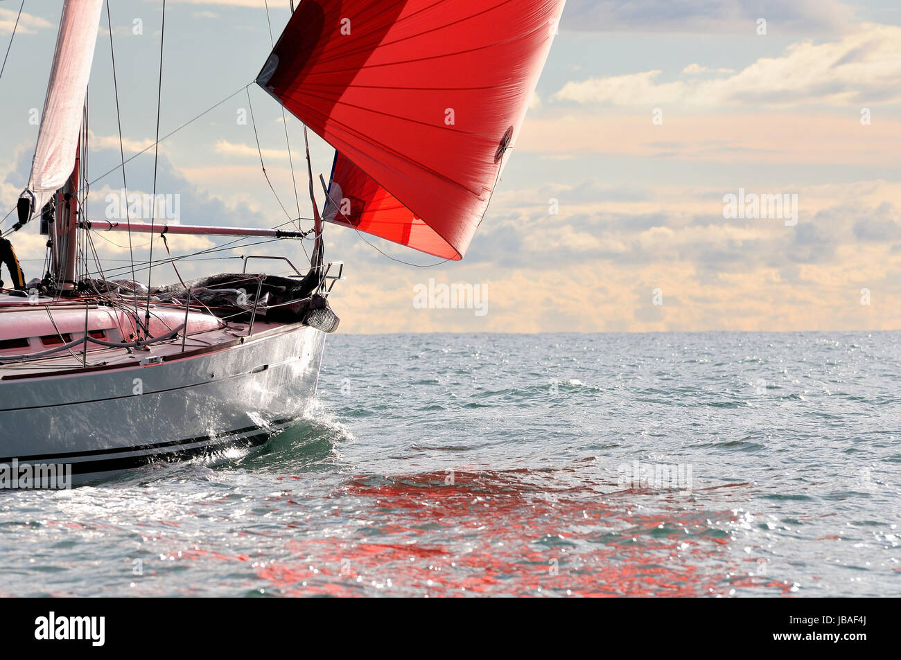 red sail at sunset Stock Photo - Alamy