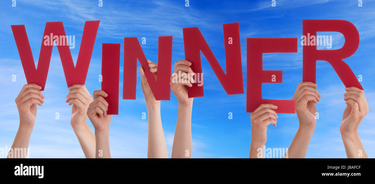 Hands Holding the Word Winner in front of a blue Sky Stock Photo - Alamy