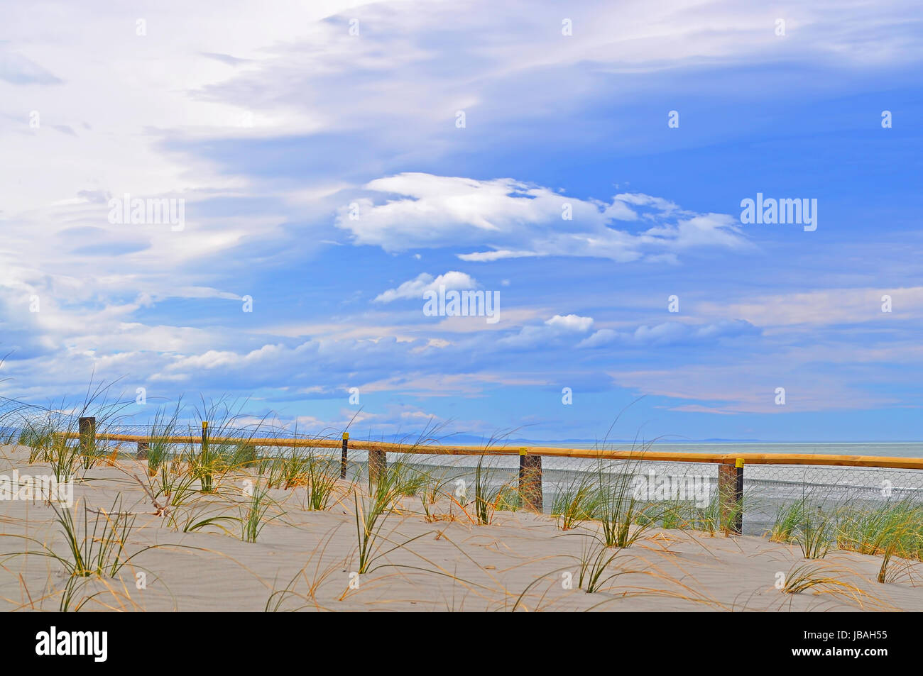 Beach fence with beautiful blue skies Stock Photo - Alamy