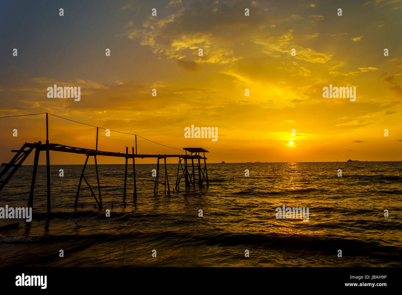Jetty with sunset background Stock Photo - Alamy