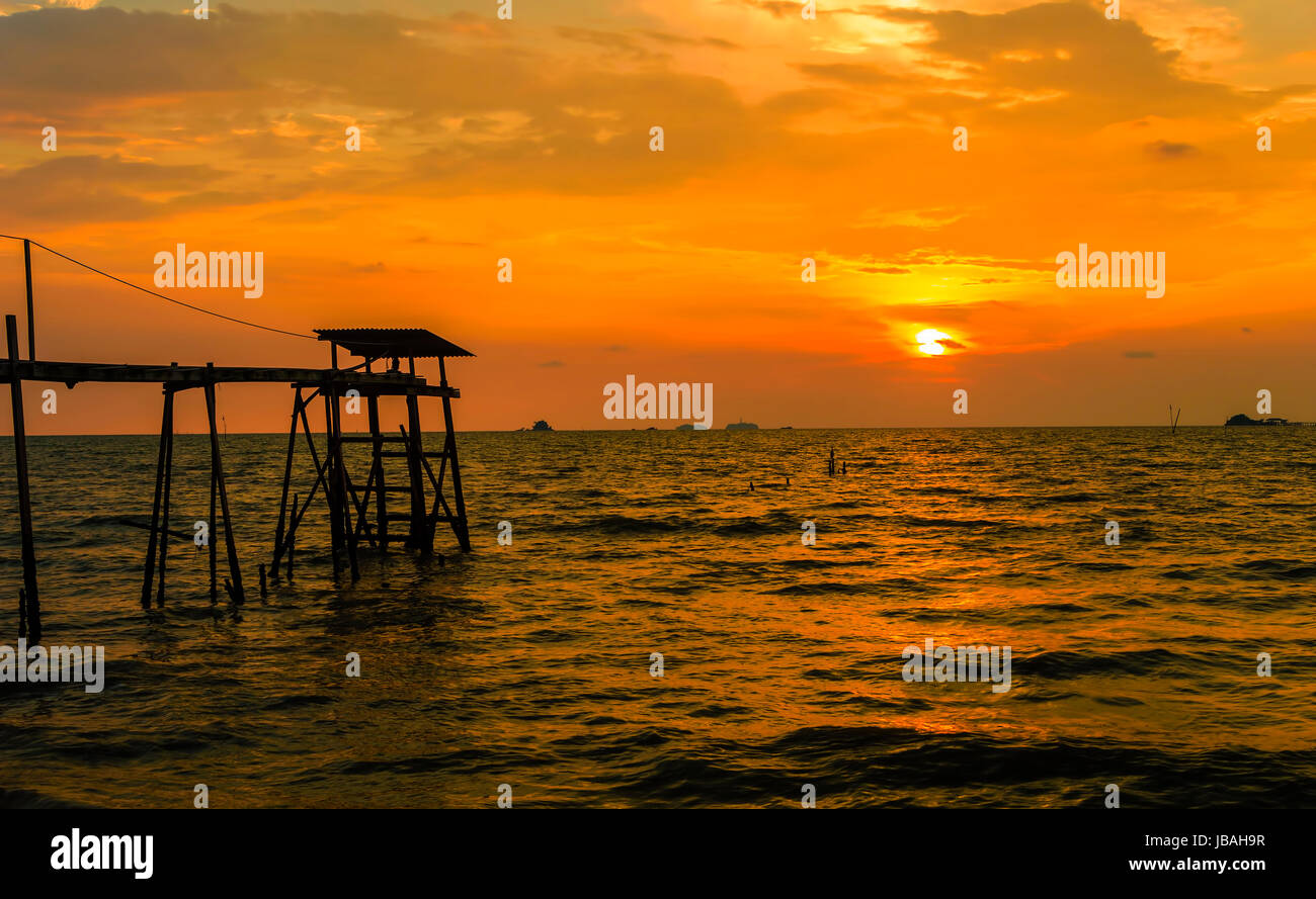 Jetty with sunset background Stock Photo - Alamy