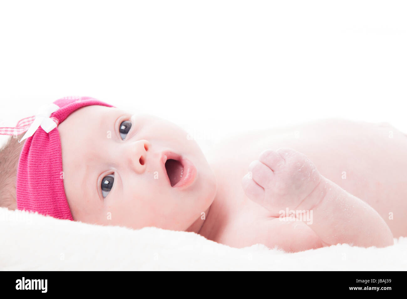 happy newborn baby girl just a week old photographed in the studio ...