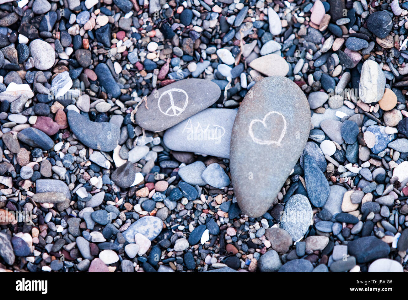 Peace and Love symbols on rocks in nature Stock Photo - Alamy