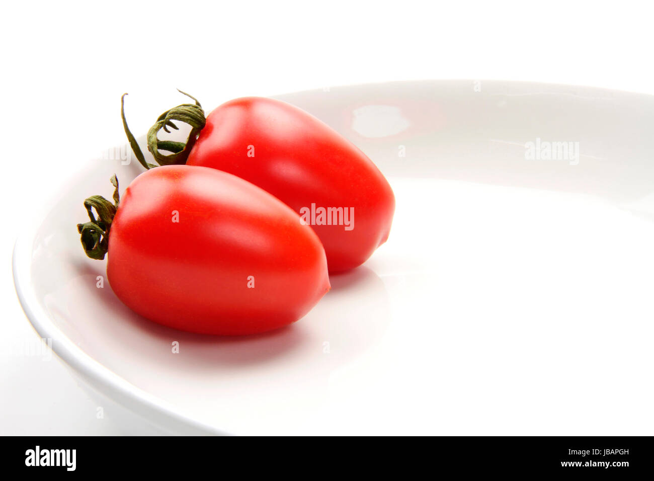 beautiful and delicious tomatoes in white porcelain plate Stock Photo ...