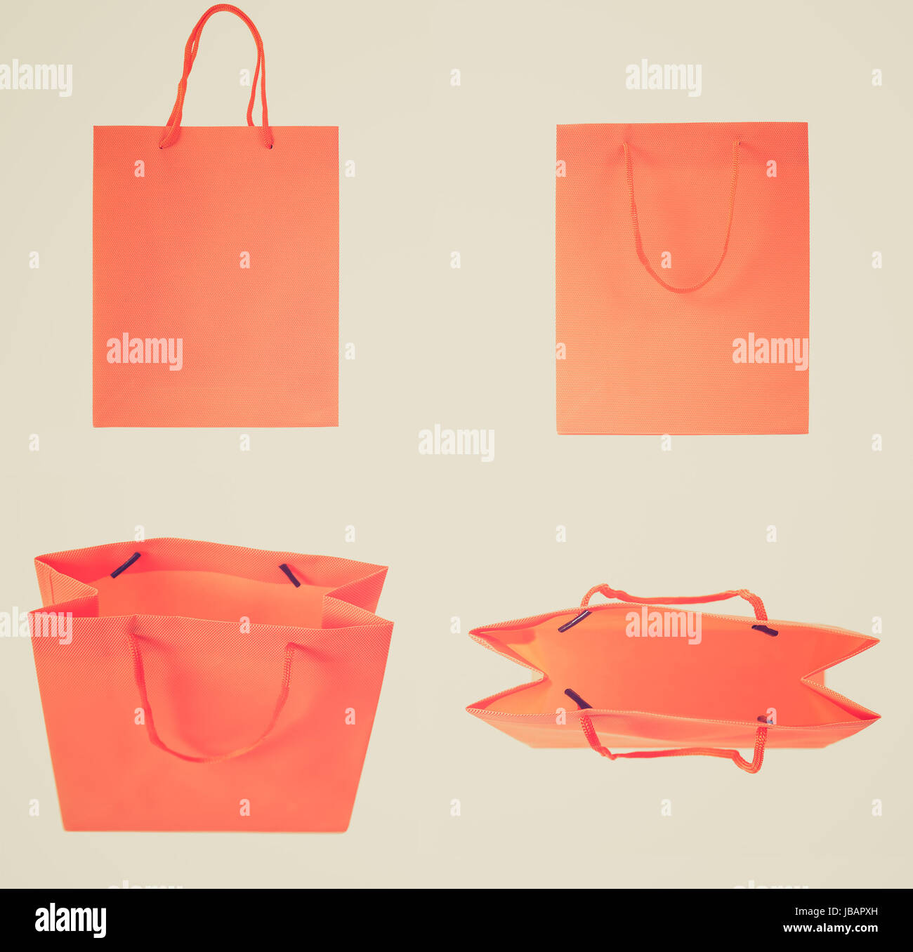 Vintage retro looking Set of orange shopping bags isolated over white ...