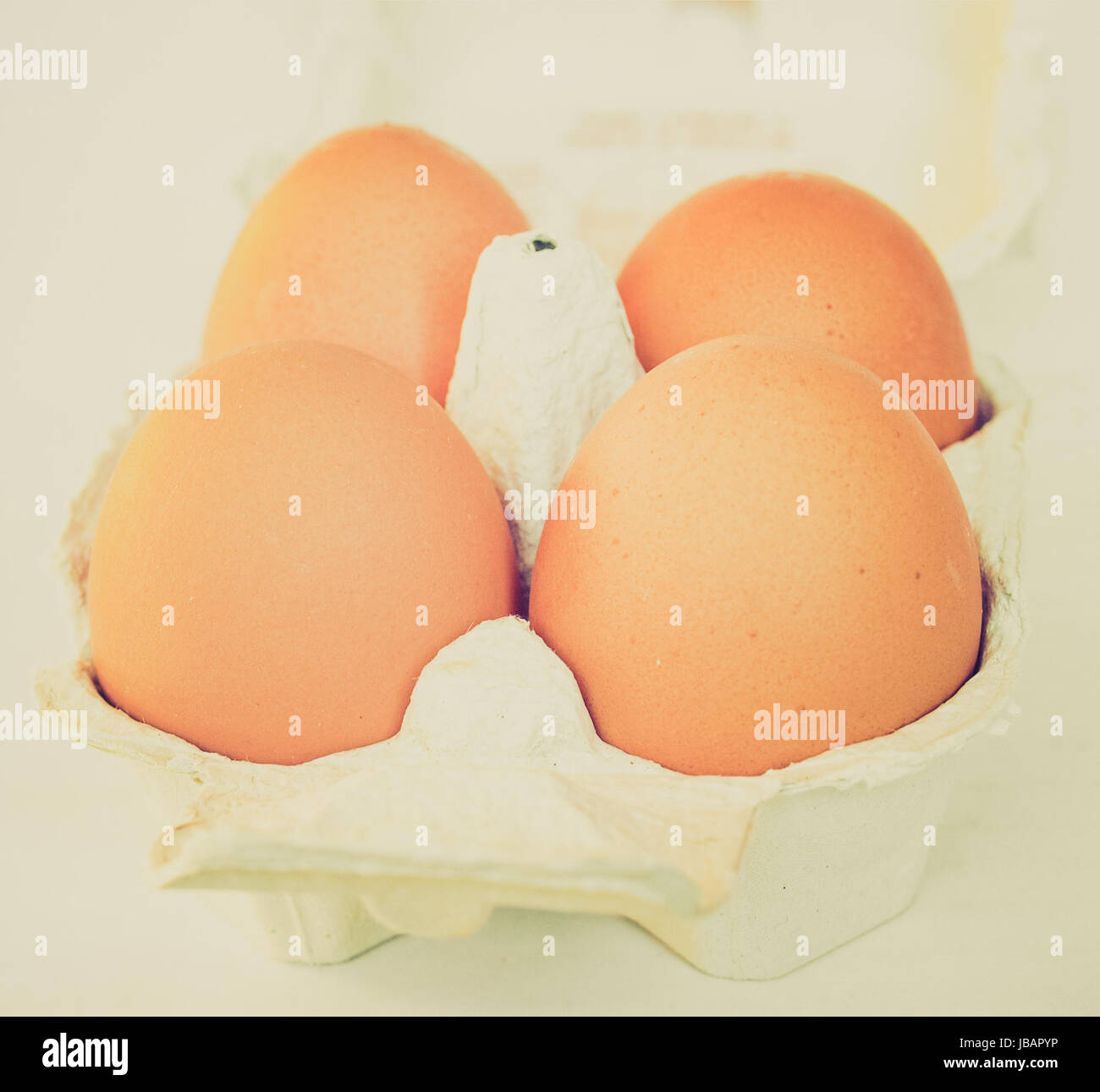 Vintage retro looking Four eggs in a cardboard wrap box Stock Photo - Alamy