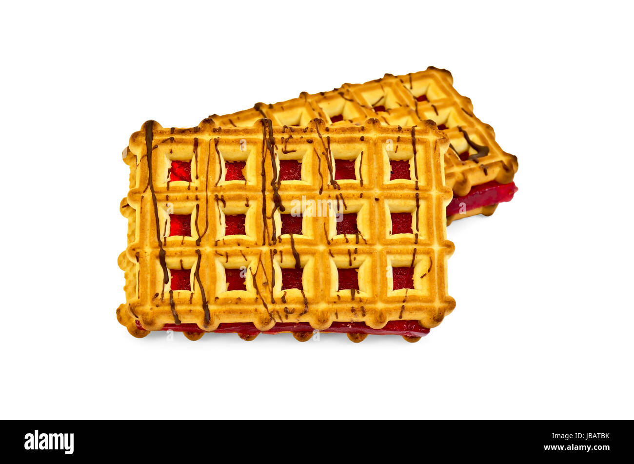 Two rectangular pastry interlayered with red jam isolated on white ...
