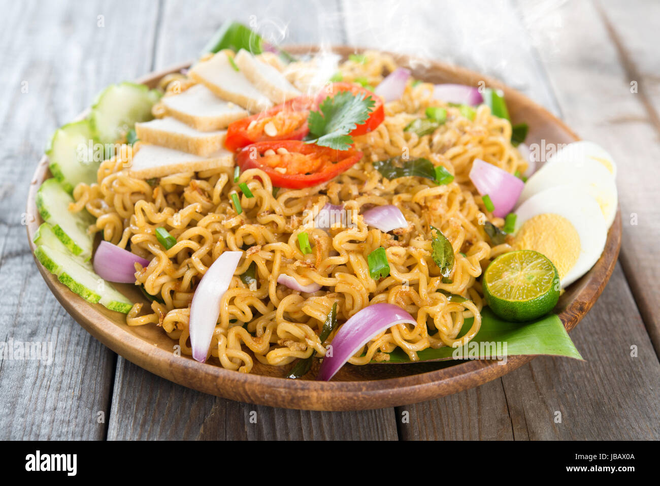 Malaysian style maggi goreng mamak or spicy fried curry instant noodles. Asian cuisine, ready to ...