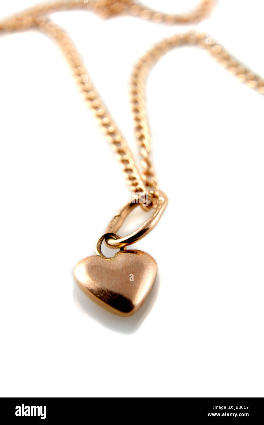 Rose Gold heart pendant with chain on white background Stock Photo - Alamy