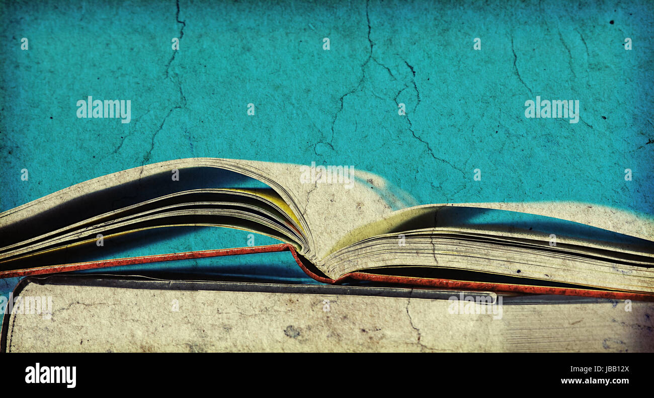 Open book in front of blue background Stock Photo - Alamy