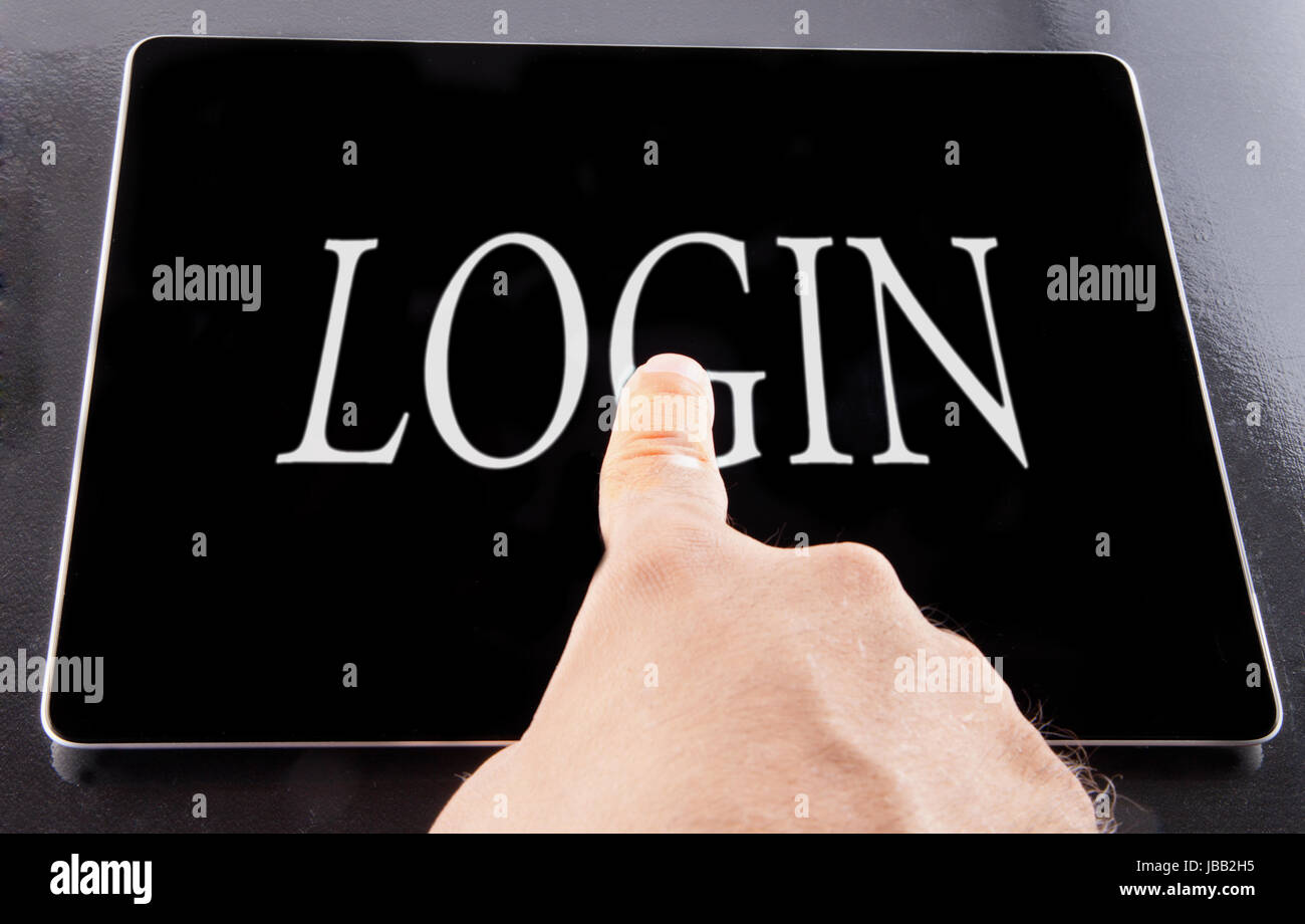 Male hand pointing to word "Login" over black tablet Stock Photo - Alamy