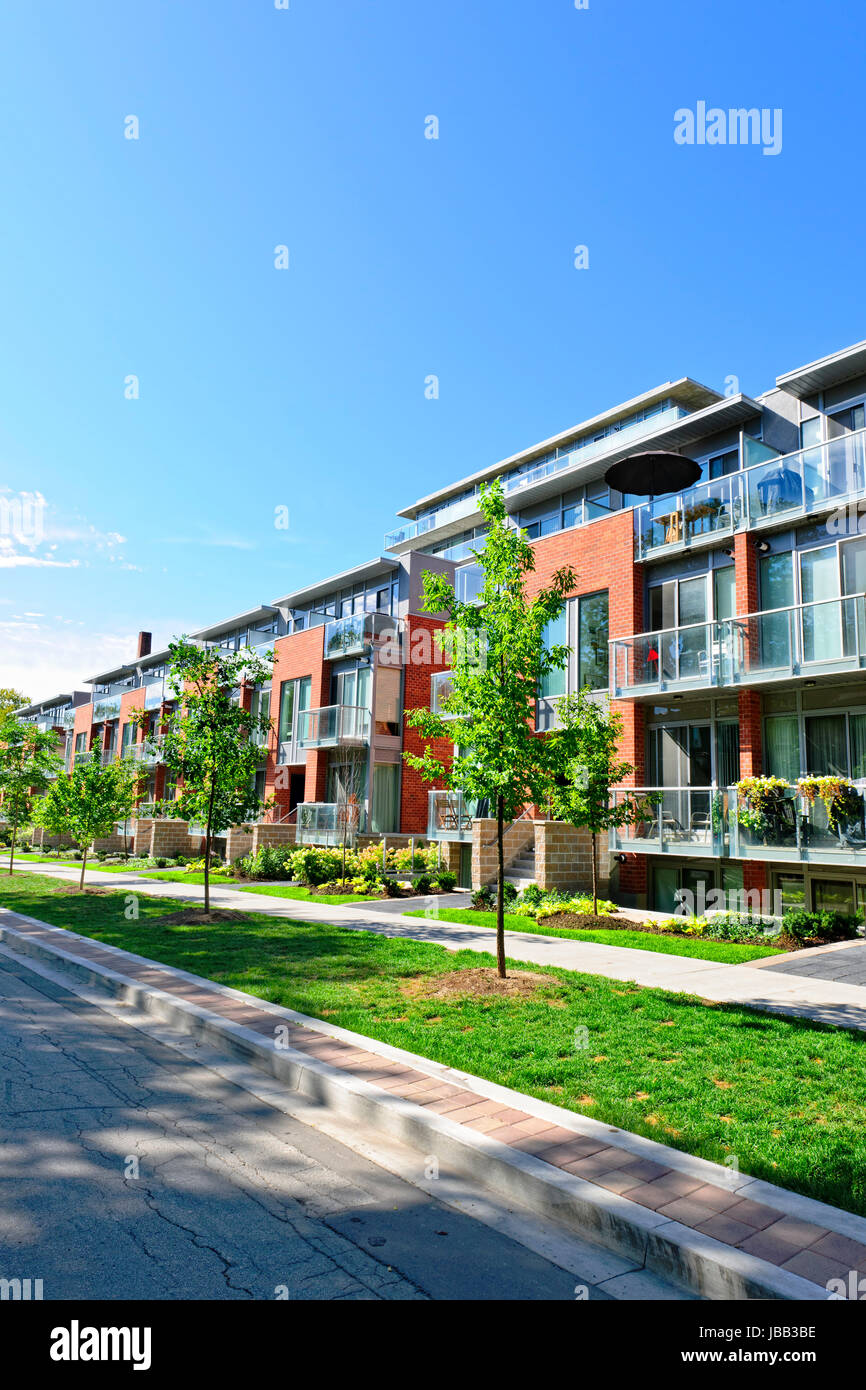 Modern town houses of brick and glass on urban street Stock Photo - Alamy