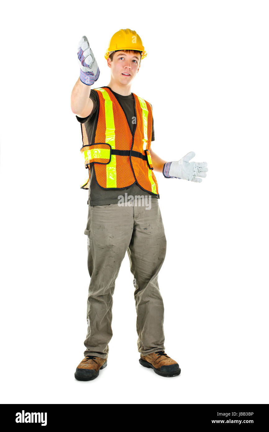 Male construction worker directing with hand signals in vest and hard ...