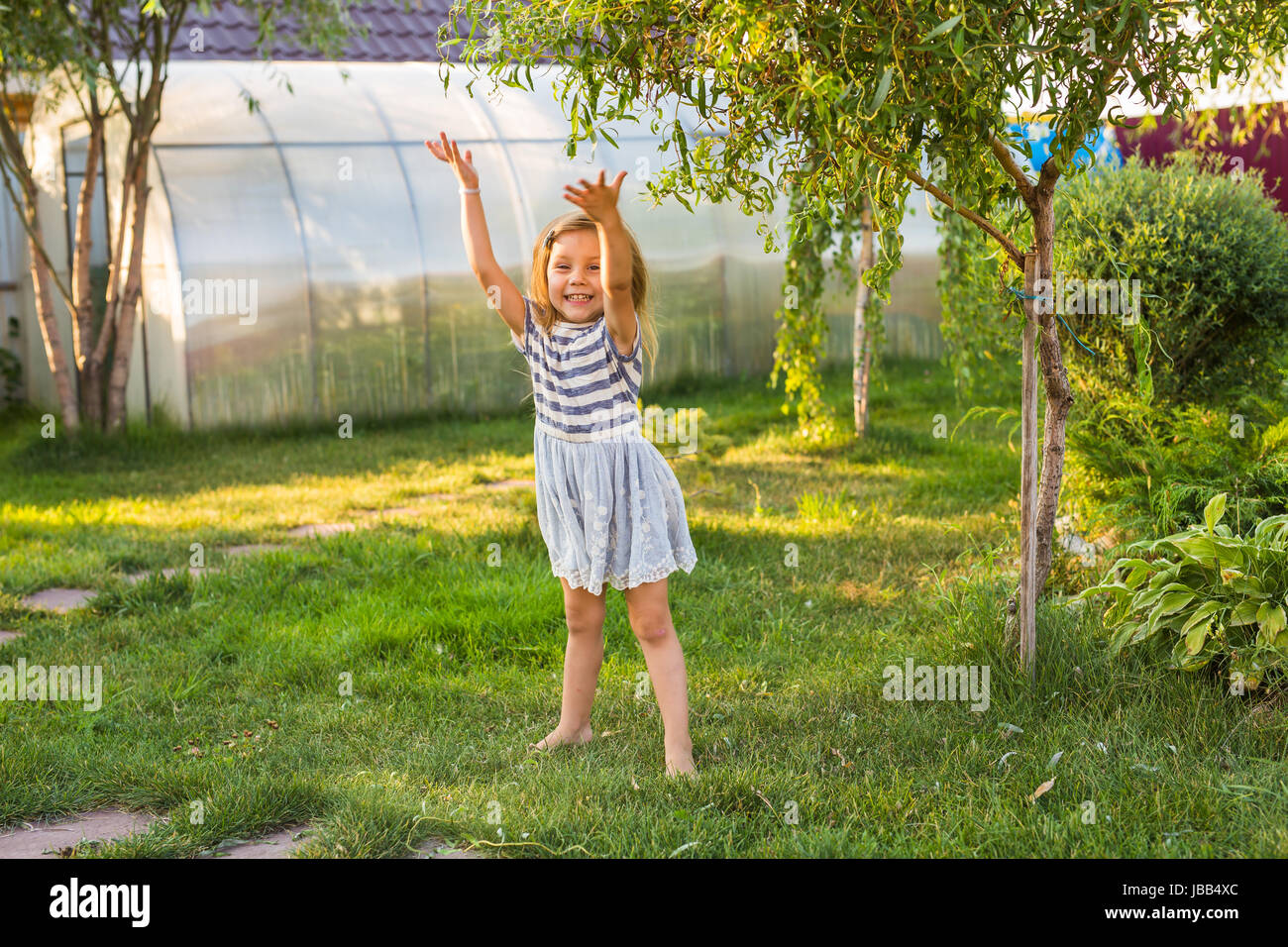 happy child girl playing in summer in nature Stock Photo - Alamy