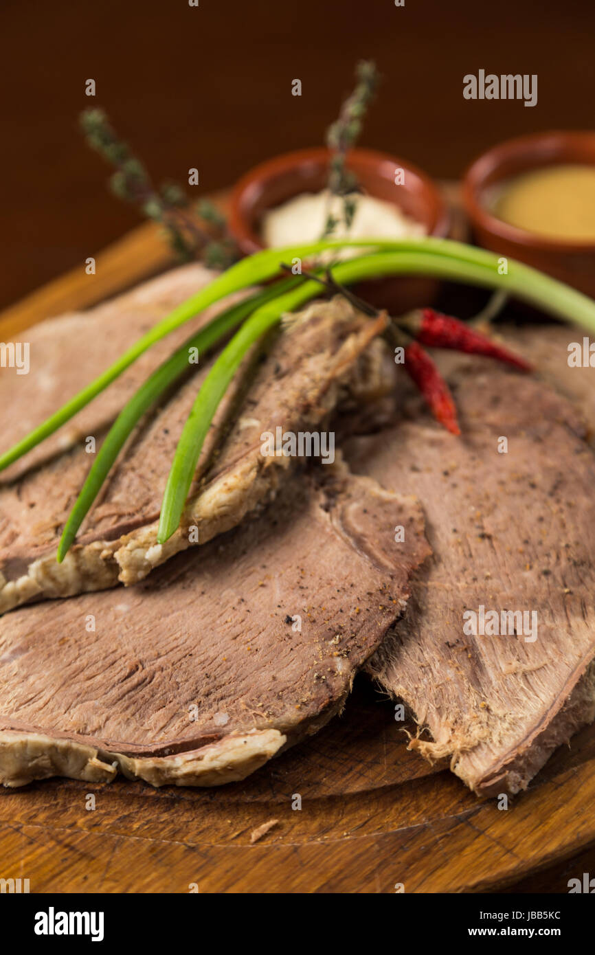 sliced boiled meat presentation on wooden board Stock Photo - Alamy