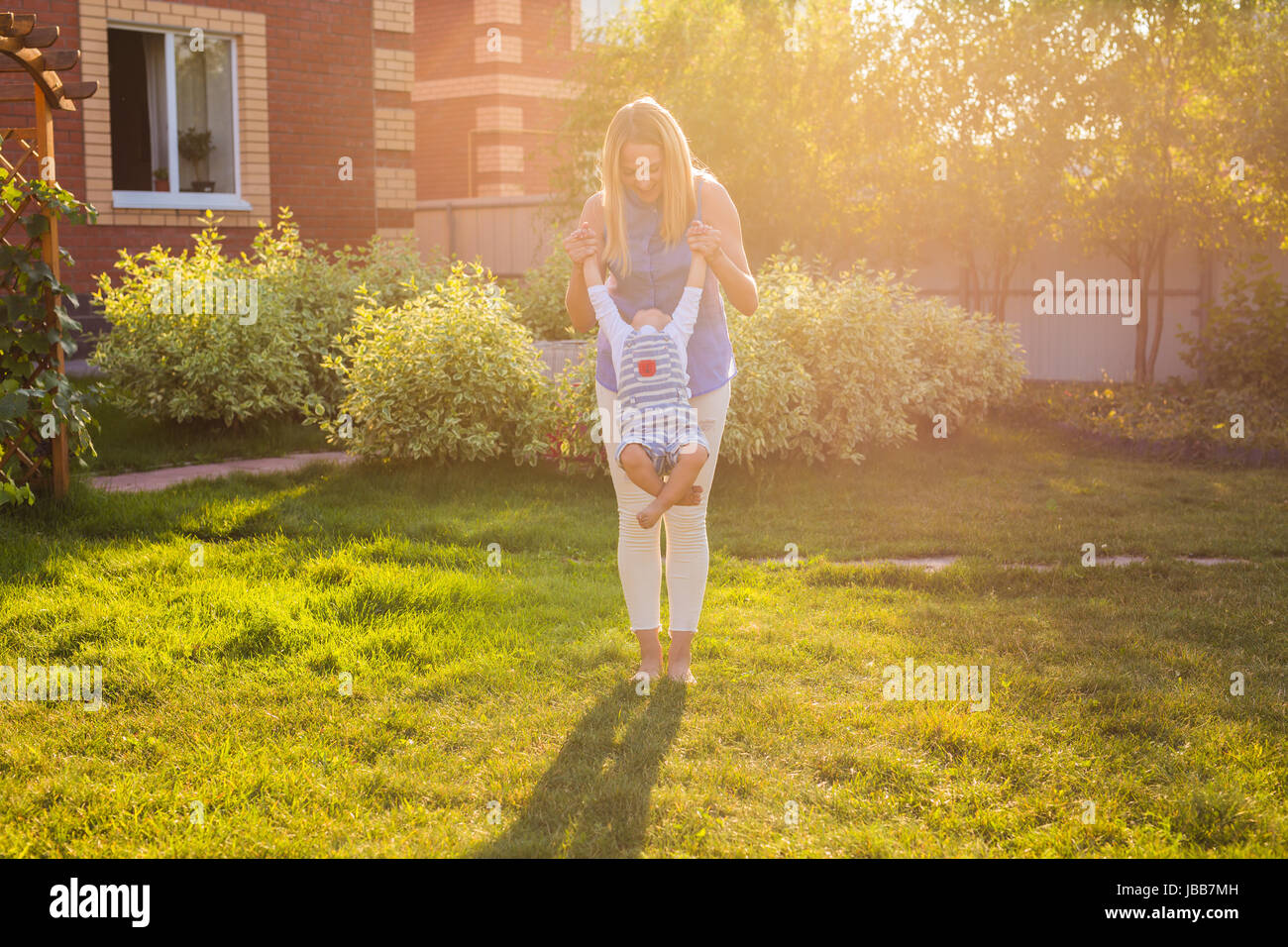 First steps with mother's help Stock Photo - Alamy