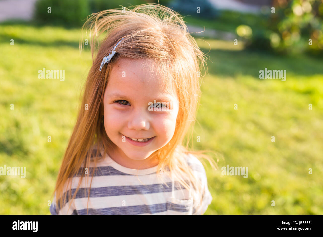 Portrait cute little girl in spring or summer day Stock Photo - Alamy