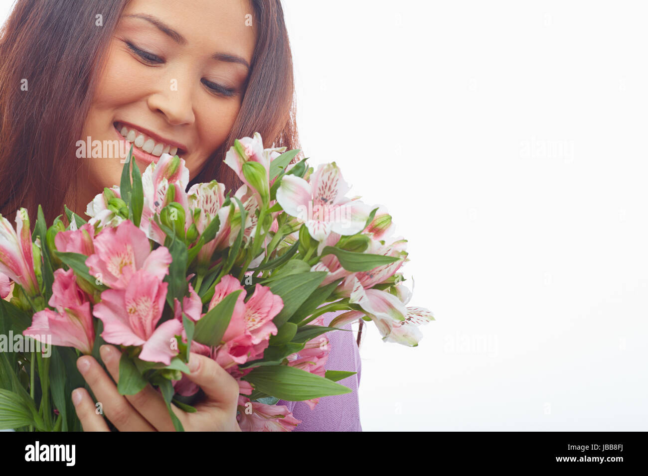 Portrait of charming female feeling smell of fresh flowers Stock Photo ...