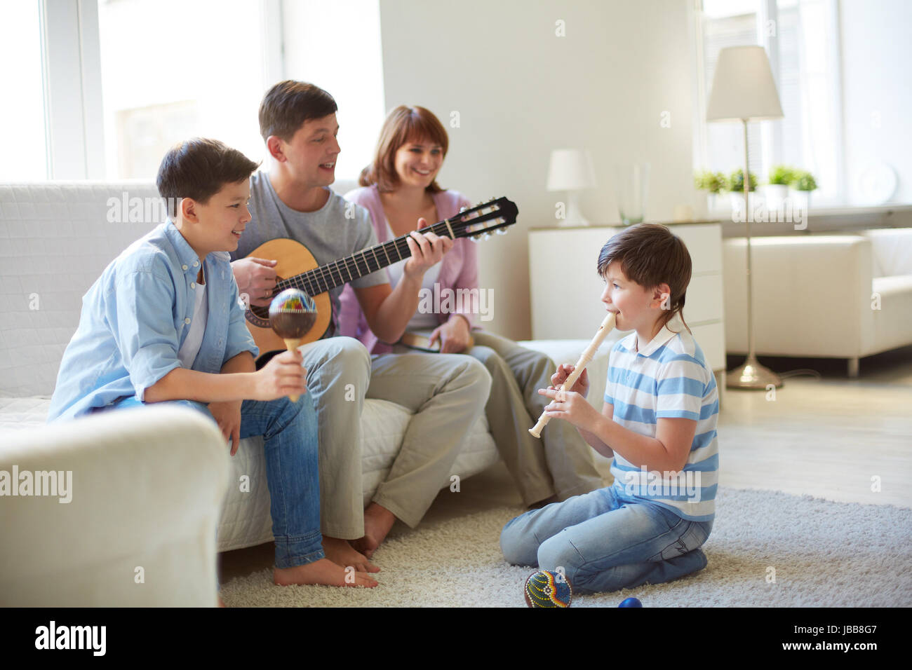 Portrait of handsome siblings and their father playing musical ...
