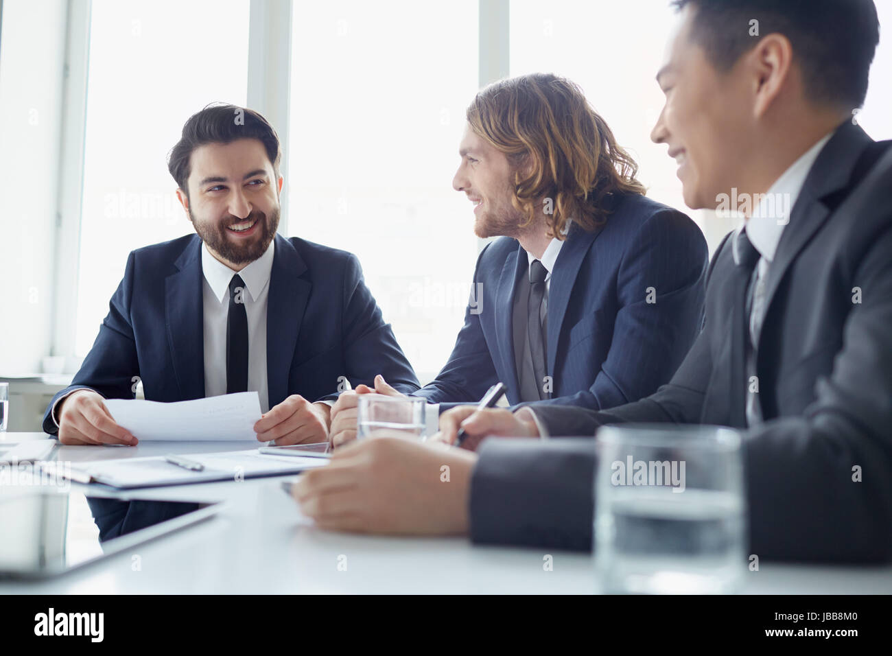 Three managers discussing business plans at meeting Stock Photo - Alamy