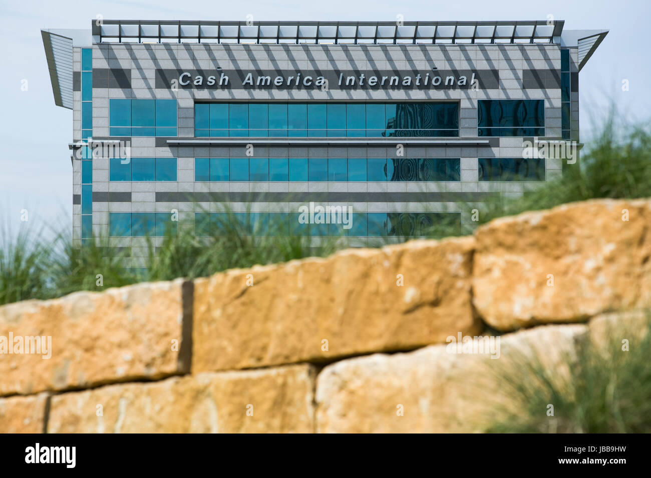 A logo sign outside of the headquarters of Cash America International ...